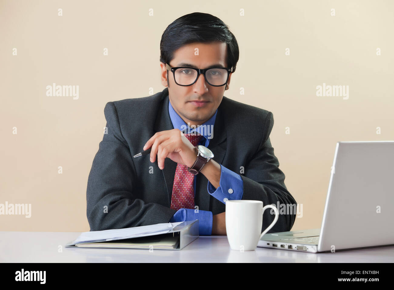 Businessman sitting at computer desk Stock Photo - Alamy