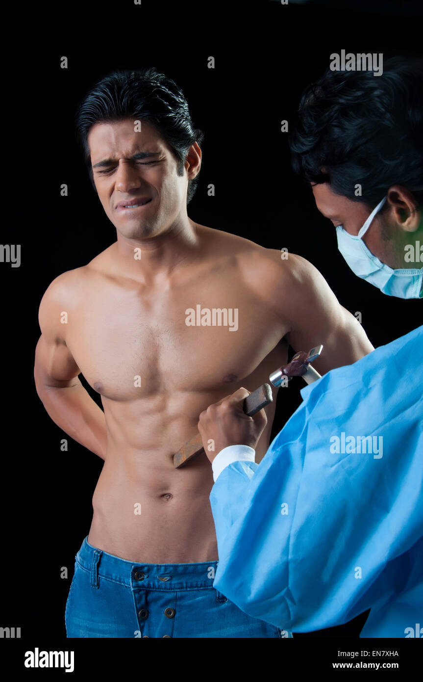 Man using chisel on muscular body Stock Photo - Alamy