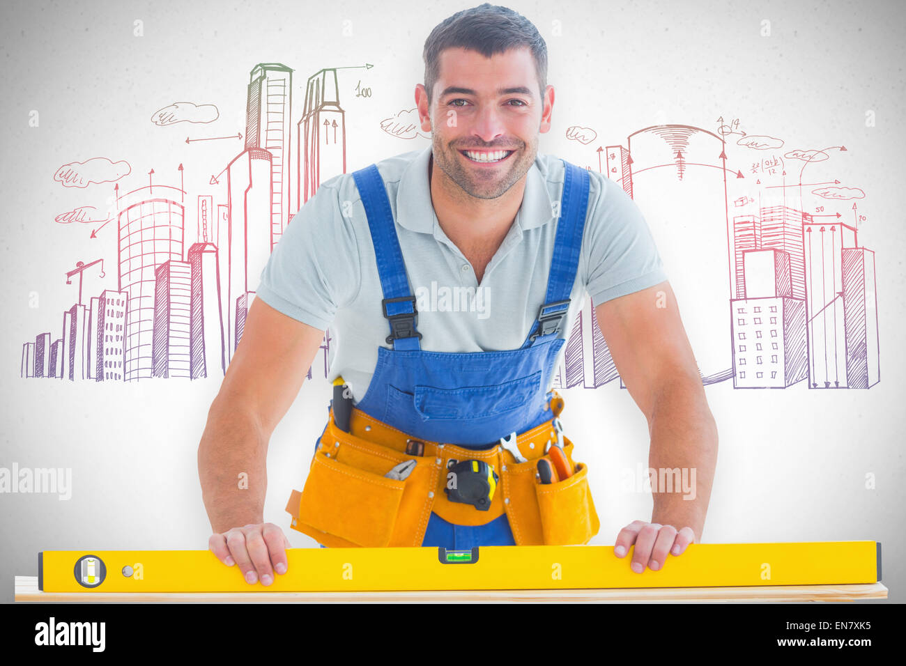 Composite image of worker using spirit level Stock Photo - Alamy