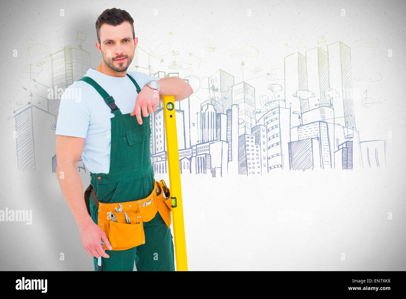 Composite image of carpenter smiling to camera with spirit level Stock ...