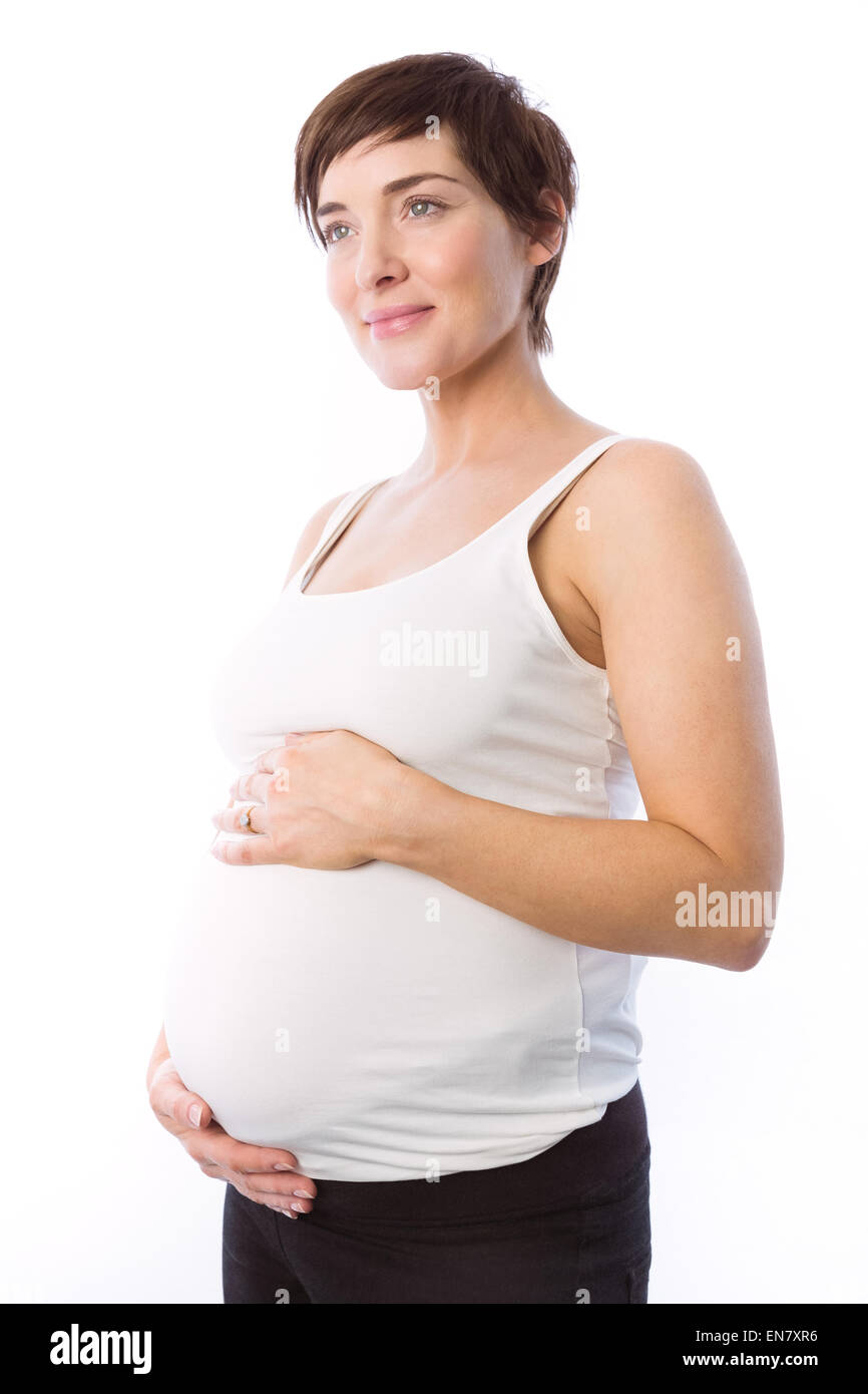 Pregnant woman holding her bump Stock Photo - Alamy