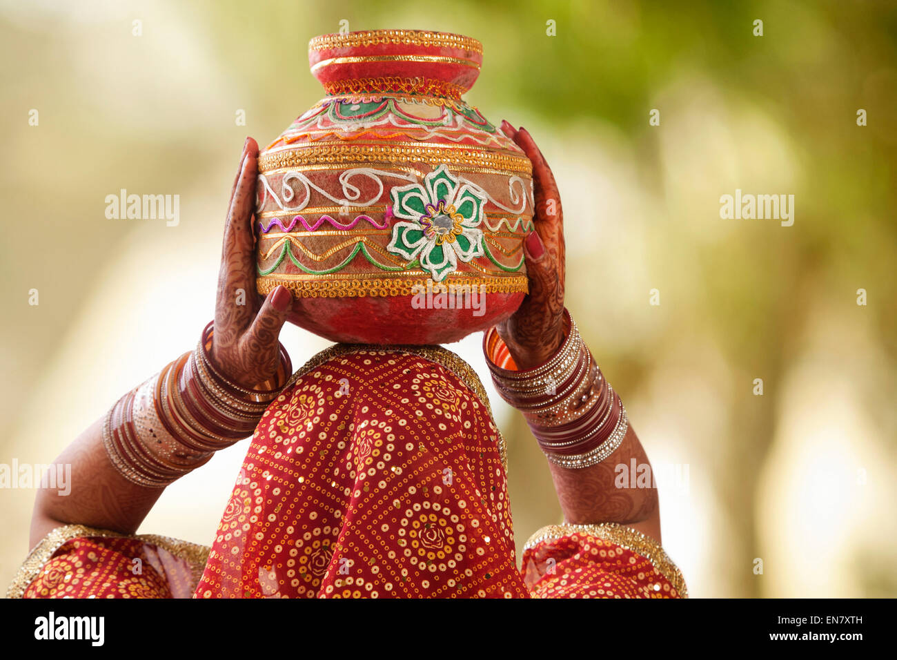 Rear view of a woman carrying designed pot Stock Photo - Alamy