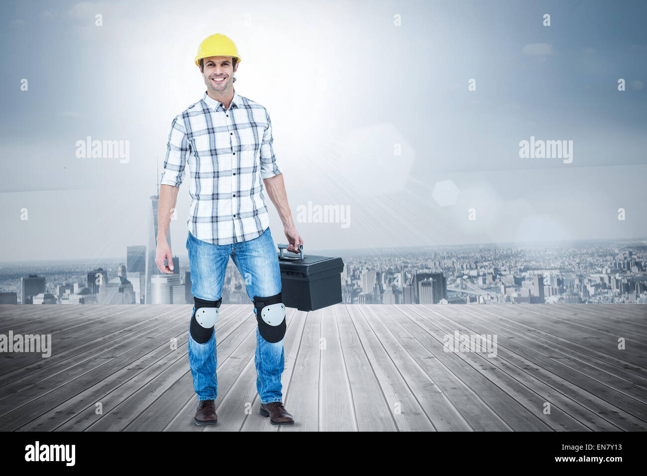 Composite image of male technician carrying tool box Stock Photo - Alamy