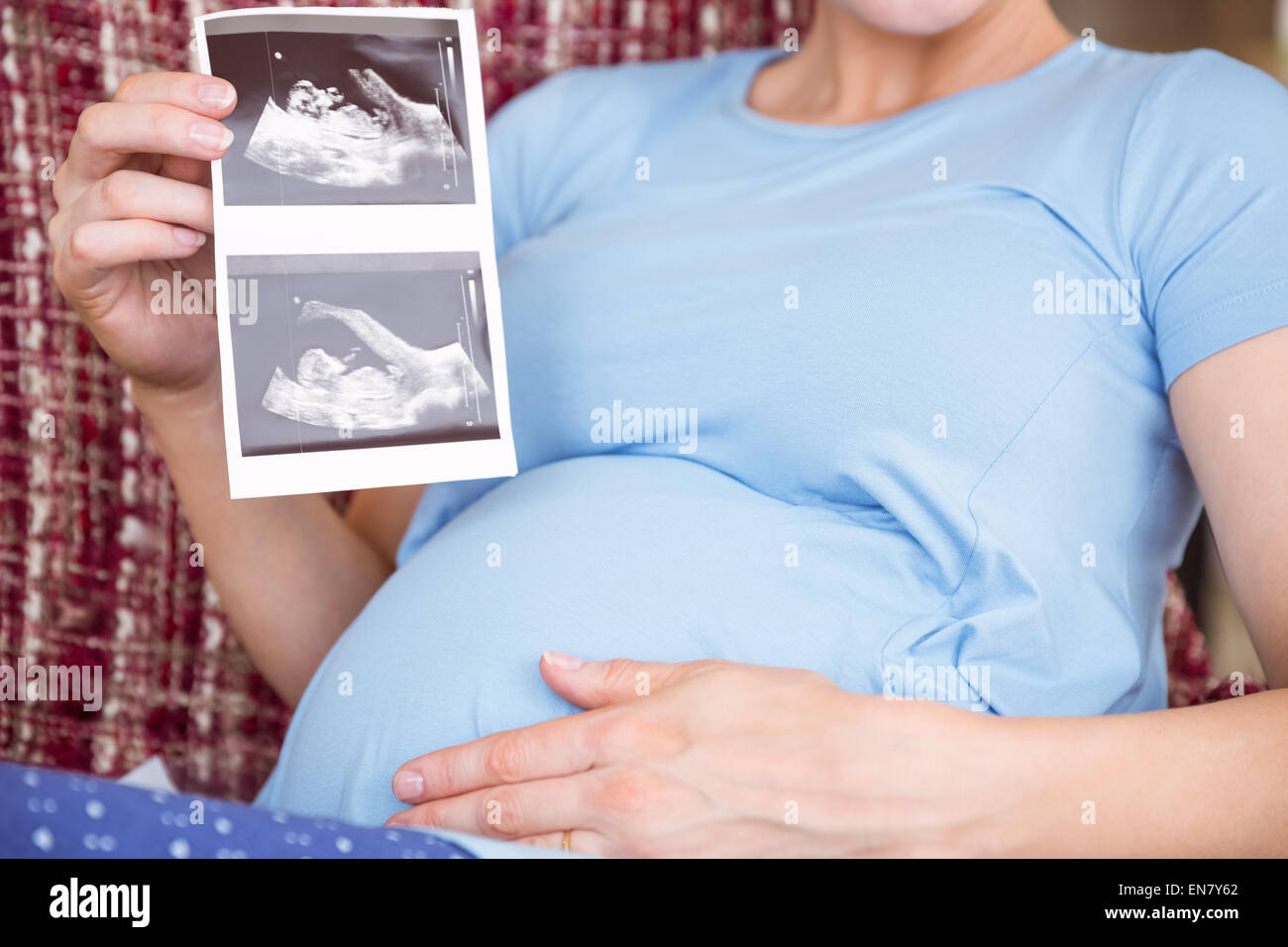 Pregnant woman looking at ultrasound scans Stock Photo - Alamy