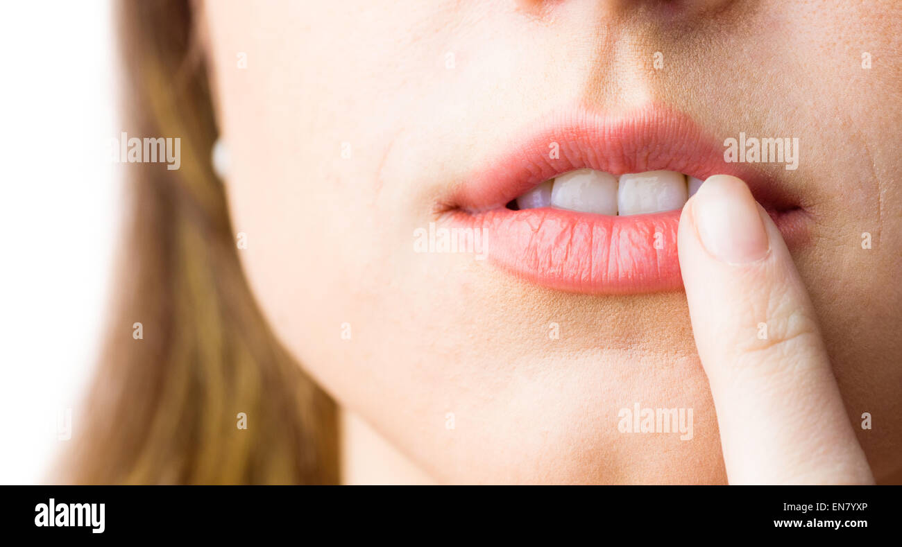 Woman pointing to her lips Stock Photo - Alamy