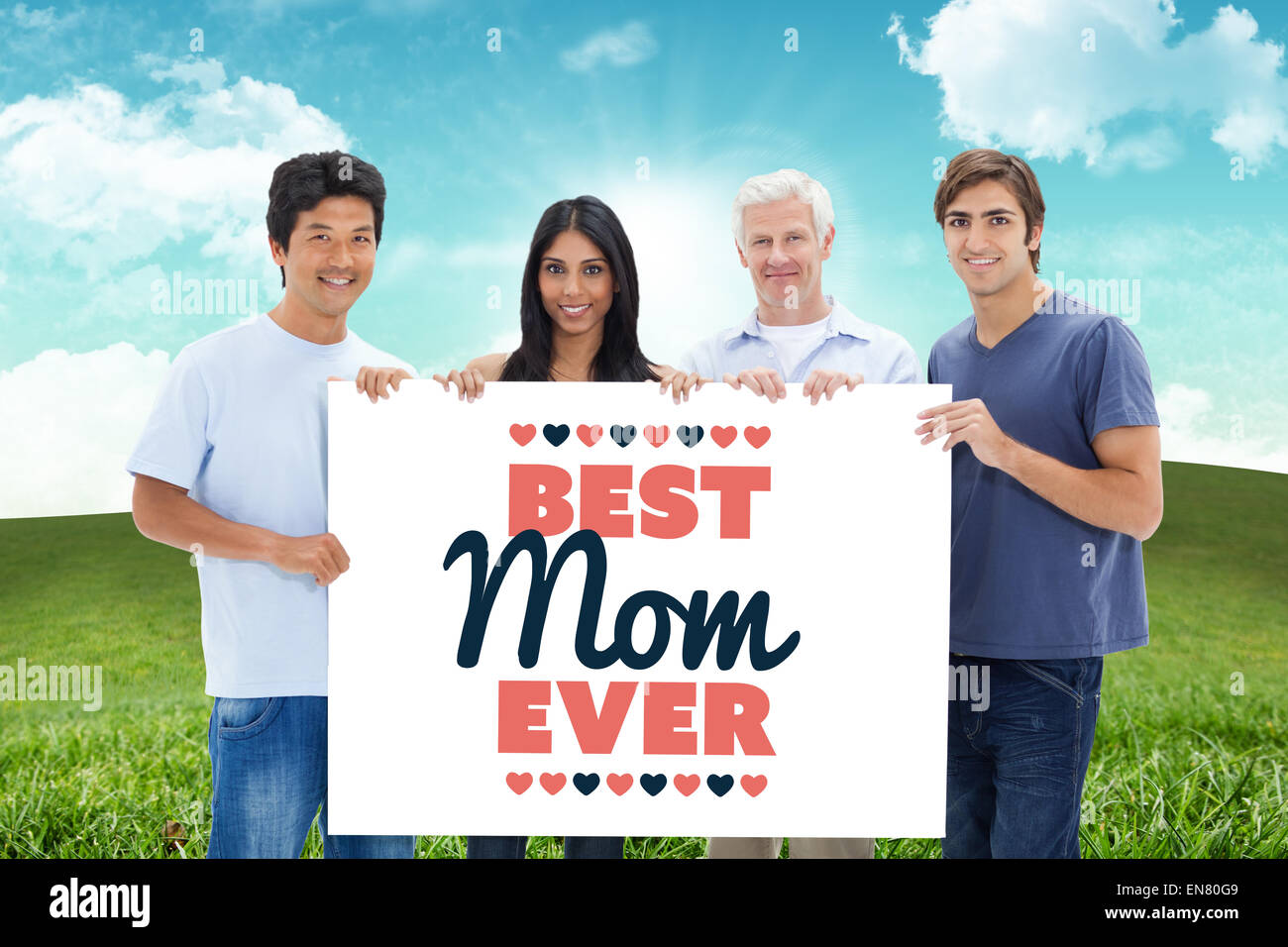 Composite image of people in jeans holding a big sign Stock Photo - Alamy