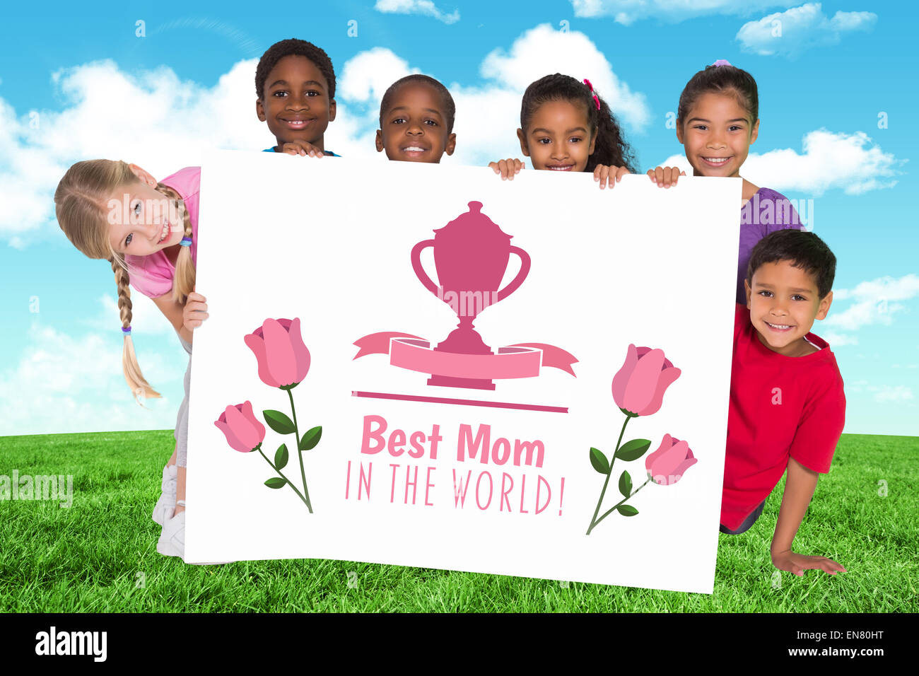 Composite image of elementary pupils showing card Stock Photo - Alamy