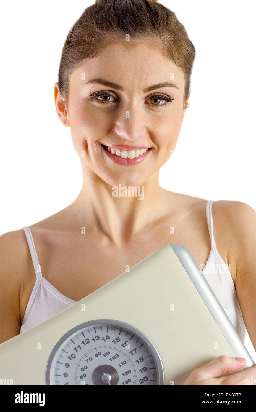 Slim woman holding weighing scales Stock Photo - Alamy