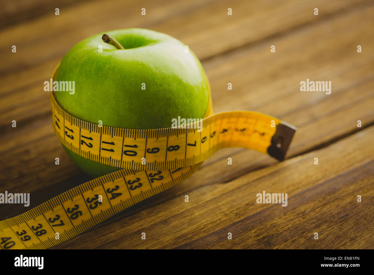 Green apple with measuring tape Stock Photo - Alamy