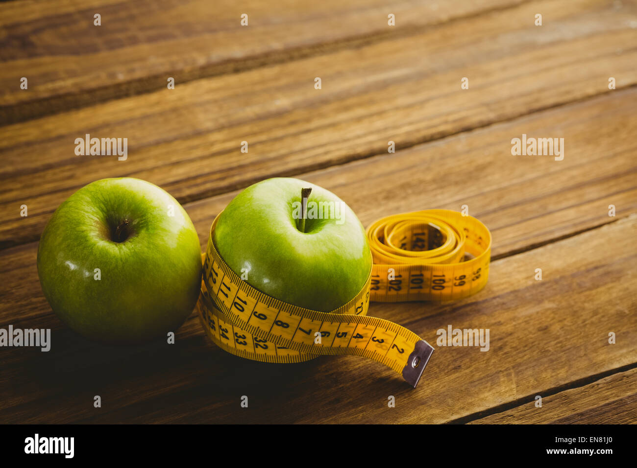 Green apples with measuring tape Stock Photo - Alamy