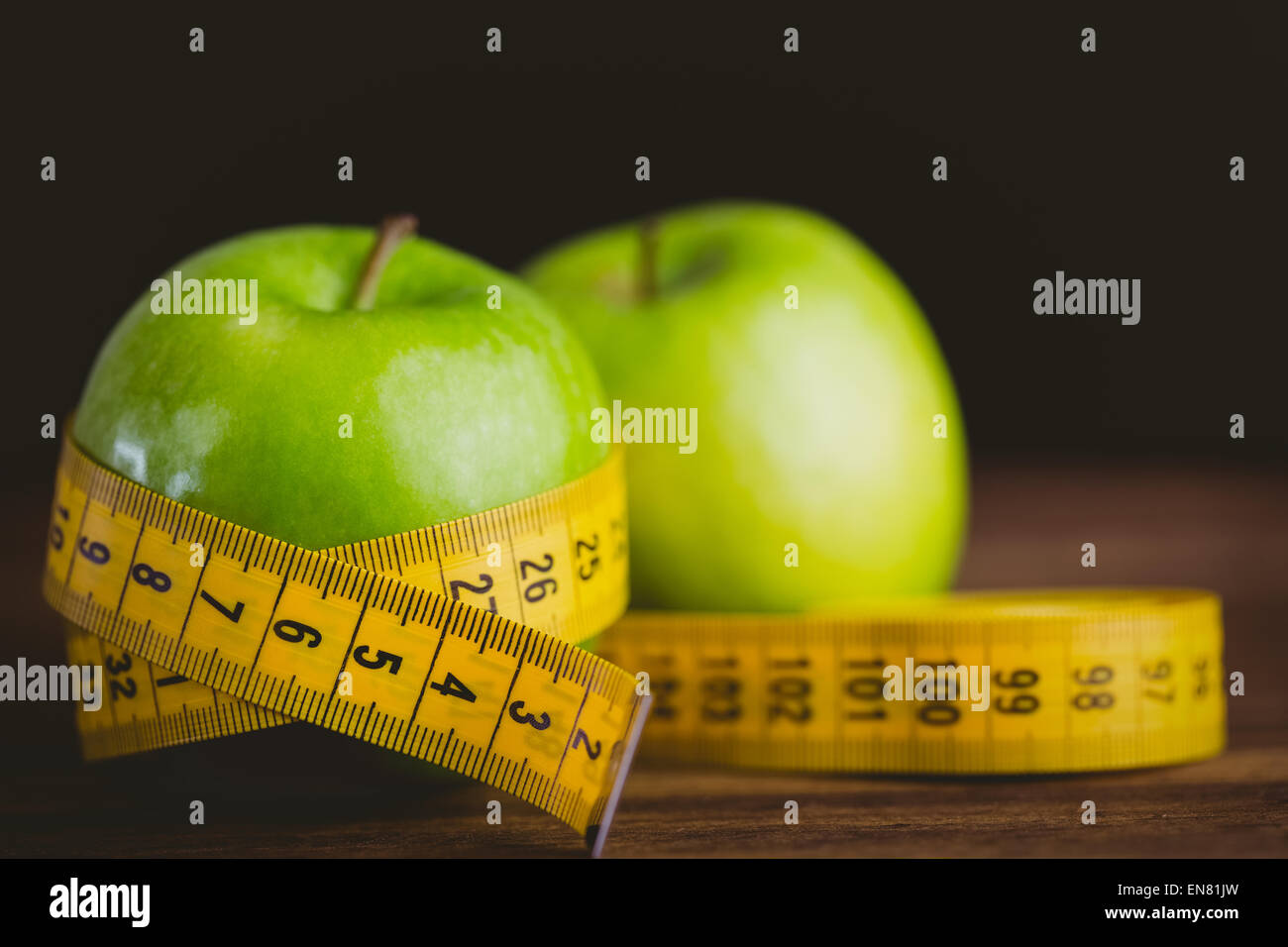 Green apples with measuring tape Stock Photo - Alamy