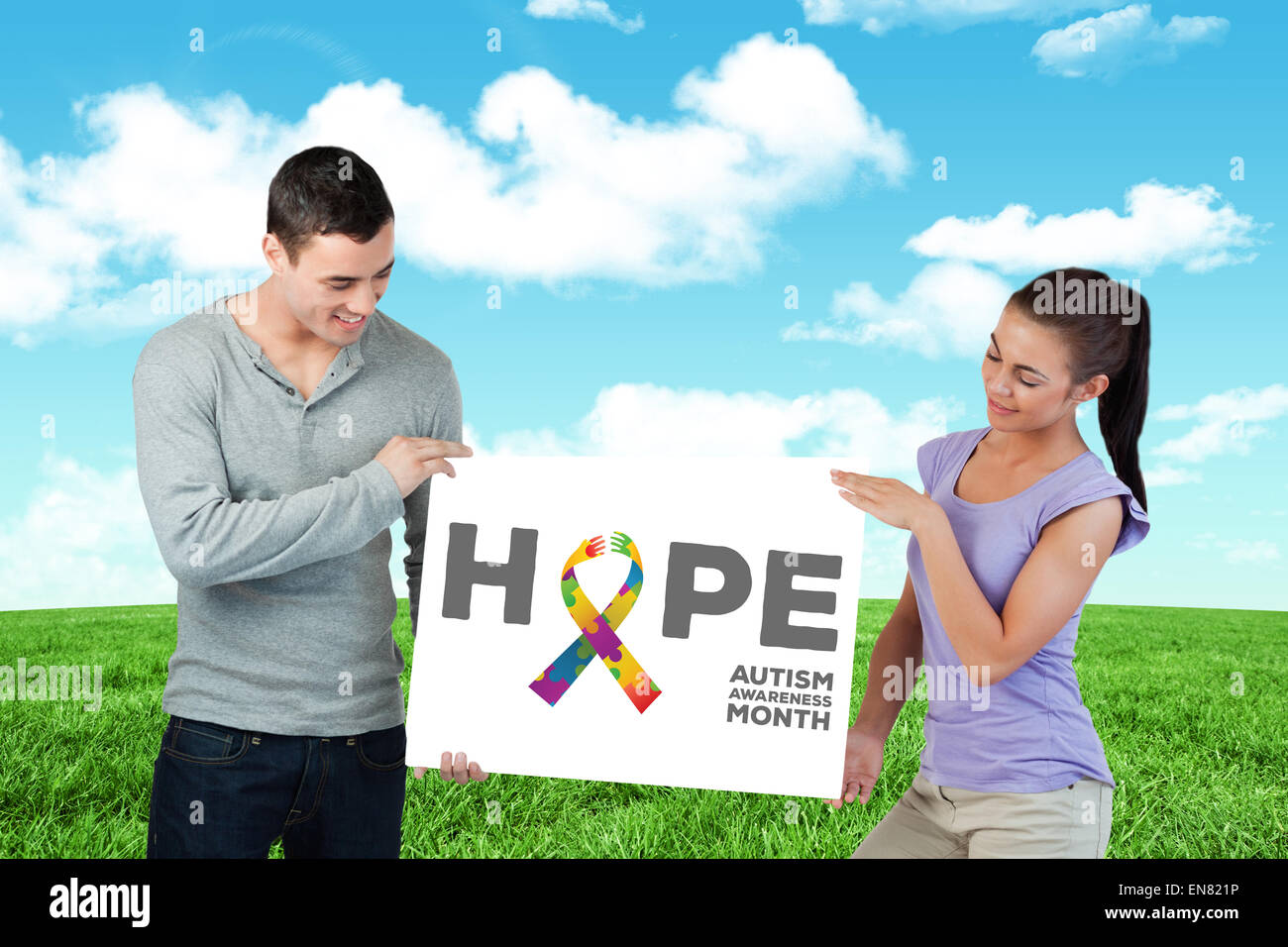 Composite image of young couple presenting banner together Stock Photo ...
