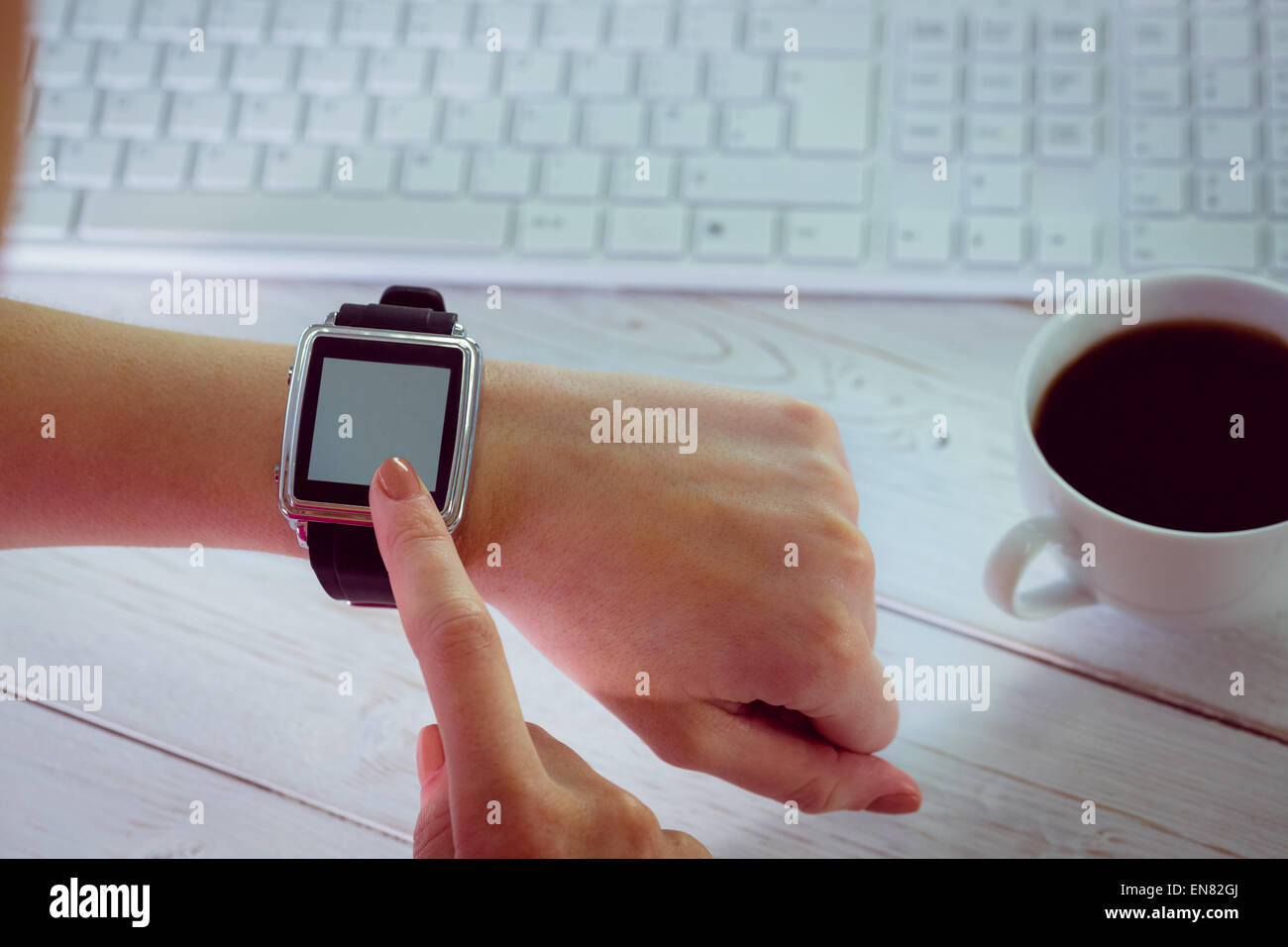 Woman using her smartwatch Stock Photo - Alamy