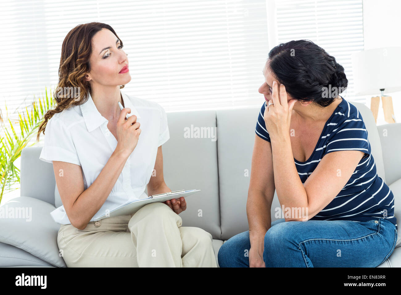 Depressed woman talking with her therapist Stock Photo - Alamy