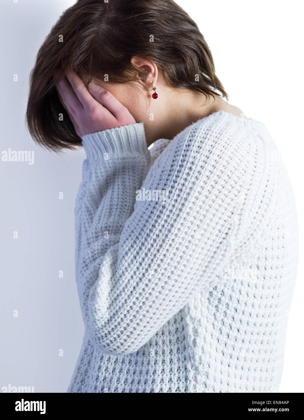 Sad pretty brunette crying with head on hands Stock Photo - Alamy