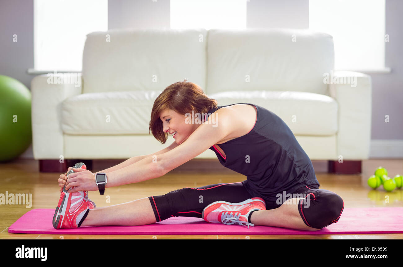 Fit woman stretching on exercise mat Stock Photo - Alamy