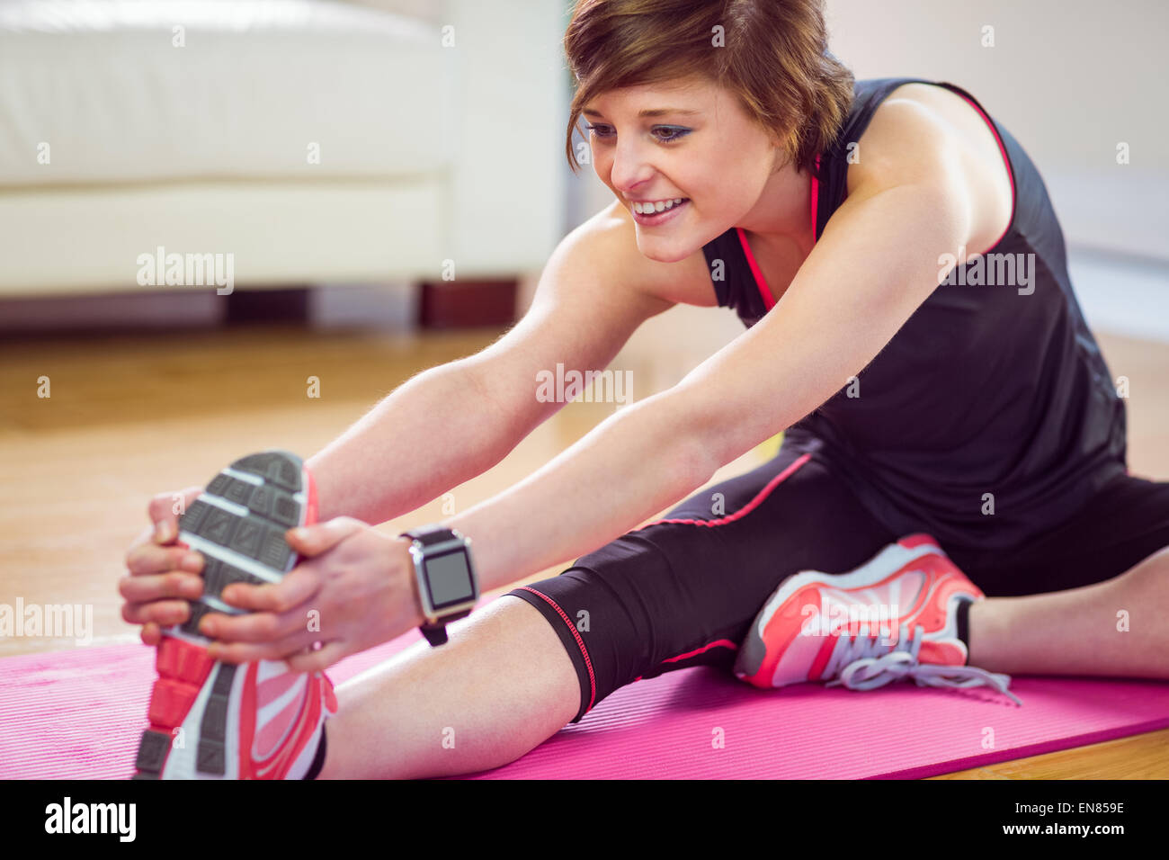 Fit woman stretching on exercise mat Stock Photo - Alamy