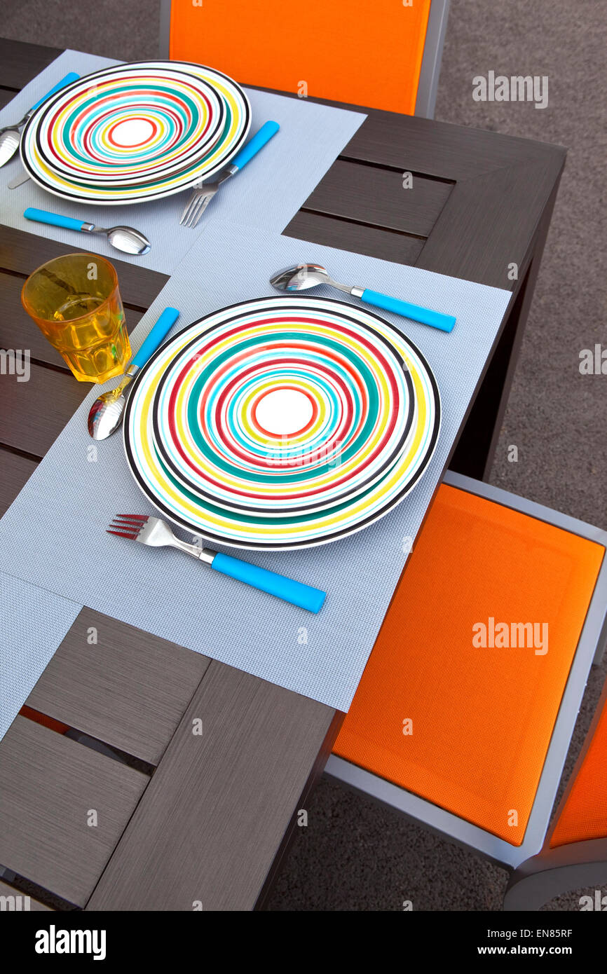 Colorful table set on the terrace at home Stock Photo - Alamy