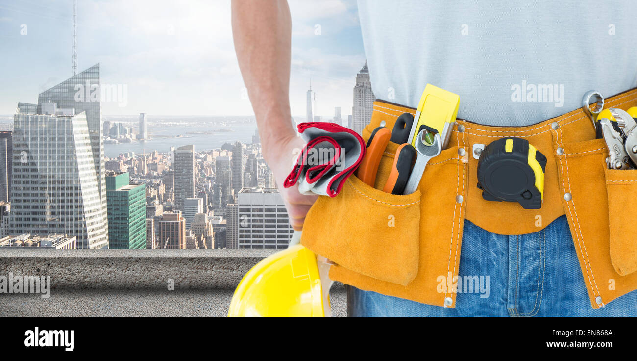 Composite image of technician with tool belt around waist Stock Photo ...