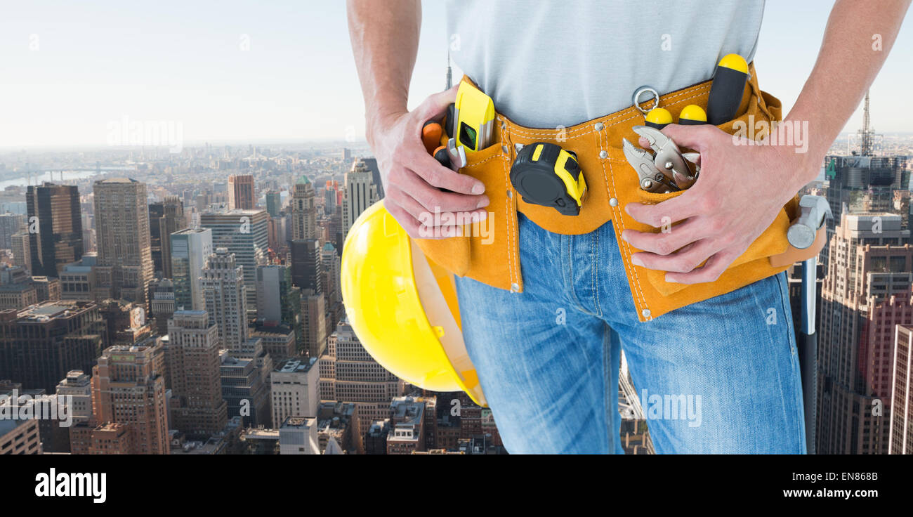 Composite image of technician with tool belt around waist Stock Photo ...
