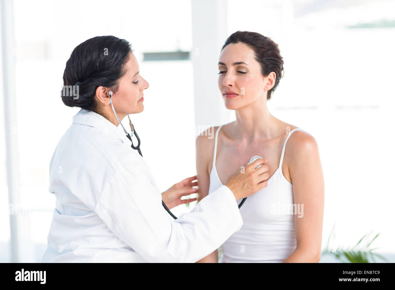 Doctor listening to patients chest with stethoscope Stock Photo - Alamy