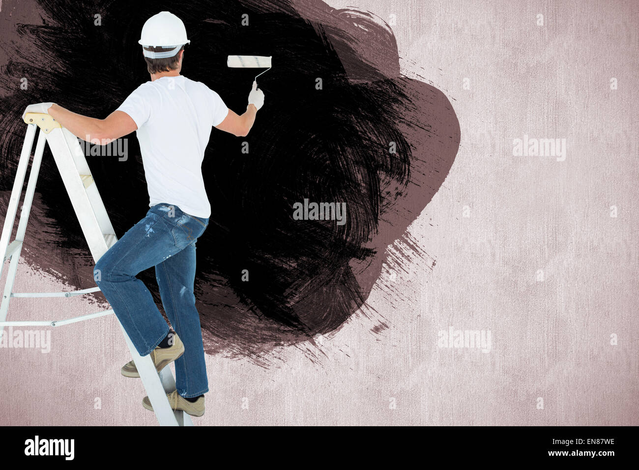 Composite image of man on ladder painting with roller Stock Photo - Alamy