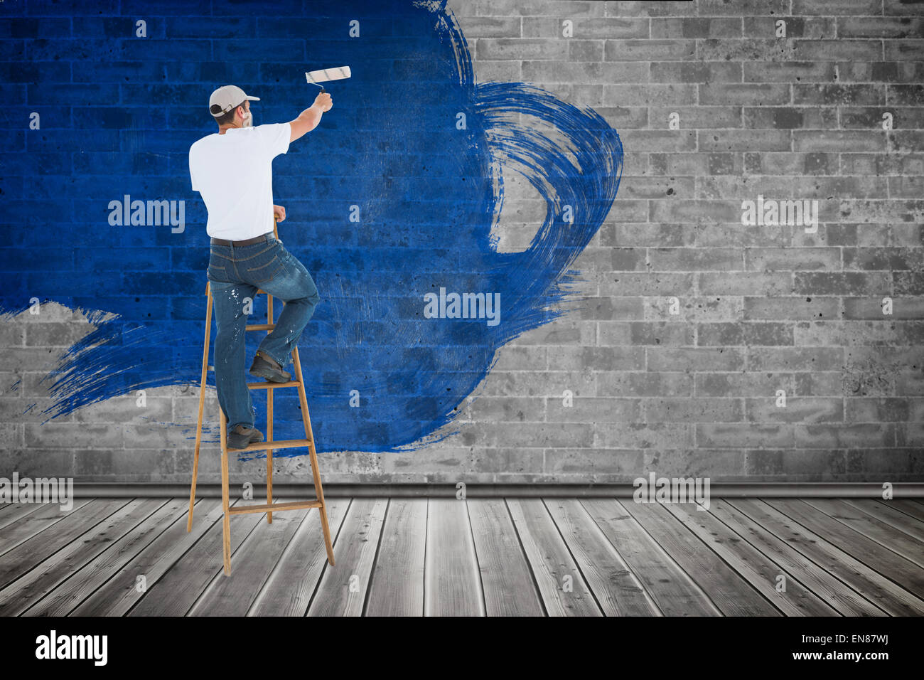 Composite image of man on ladder painting with roller Stock Photo - Alamy