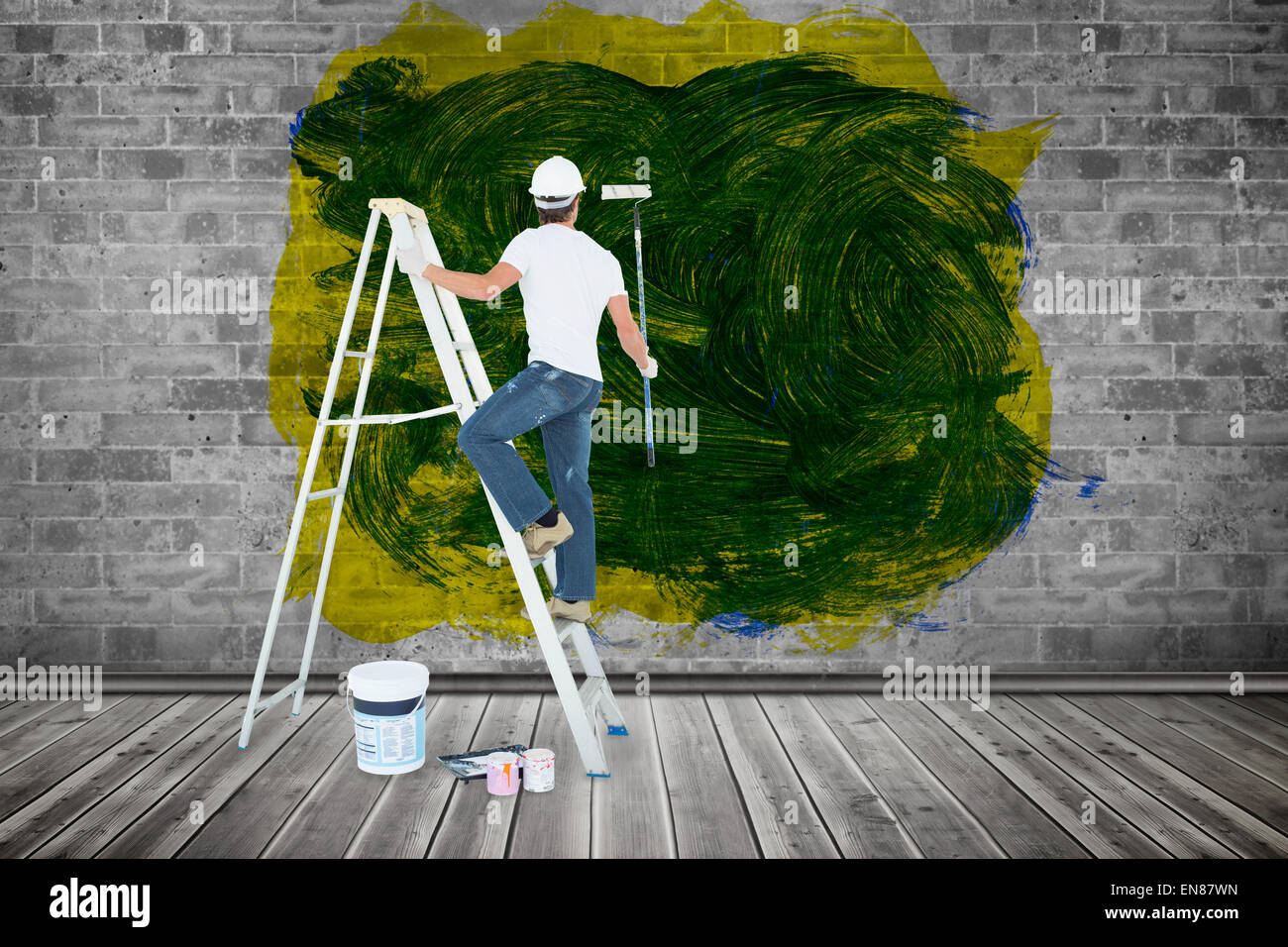 Composite image of man on ladder painting with roller Stock Photo - Alamy
