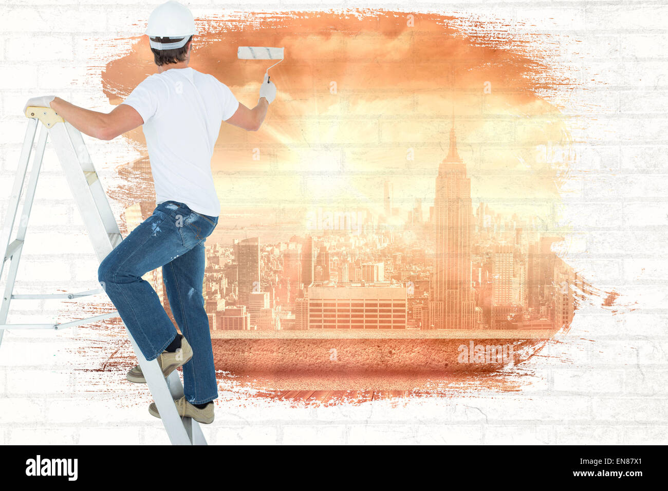 Composite image of man on ladder painting with roller Stock Photo - Alamy