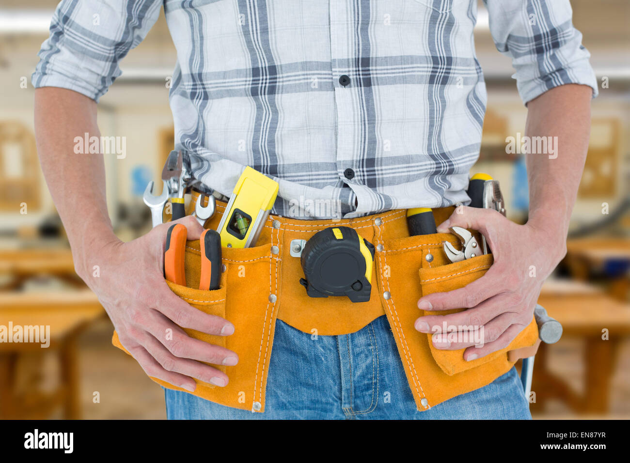 Composite image of cropped image of technician with tool belt around ...