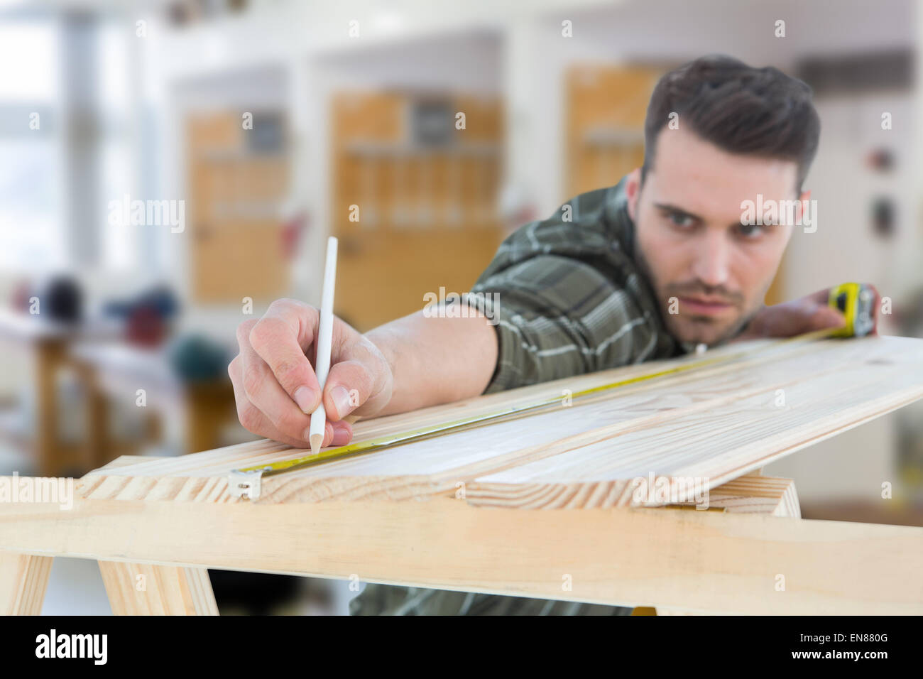 Worker marking wood with pencil hi-res stock photography and images - Alamy