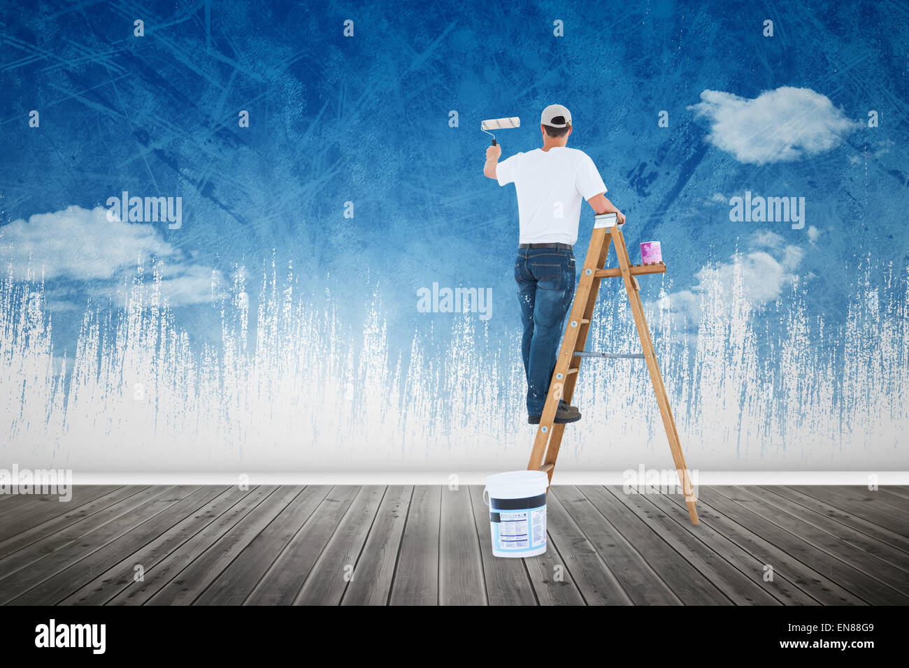 Composite image of man on ladder painting with roller Stock Photo - Alamy