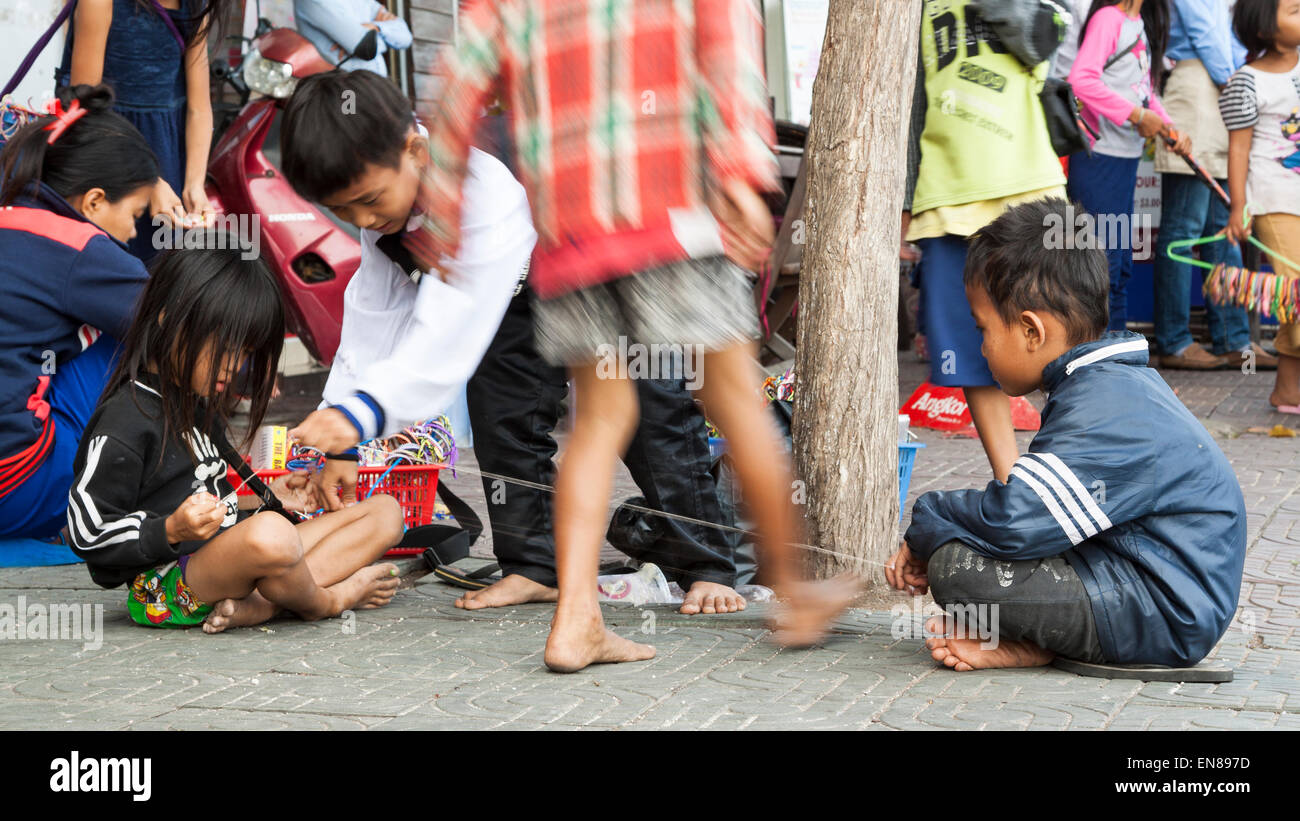Cambodian children having little fun, while sell bracelets to the ...