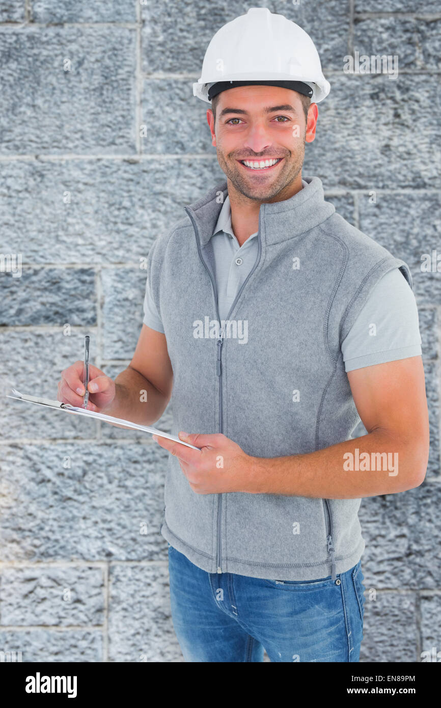 Composite image of portrait of smiling supervisor writing on clipboard ...