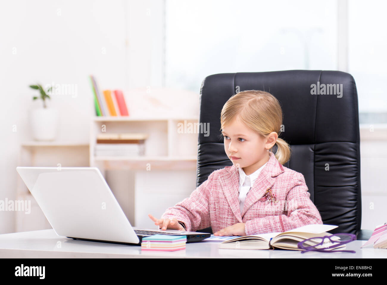 Little cute girl playing role of business woman Stock Photo - Alamy