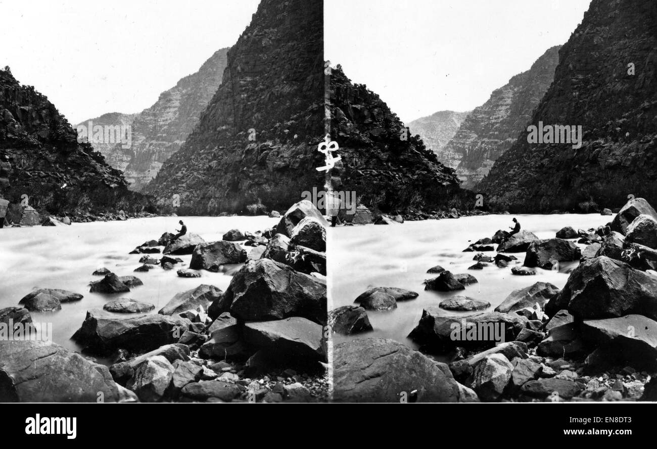 This photograph captures Clem Powell sitting on a boulder and reading ...