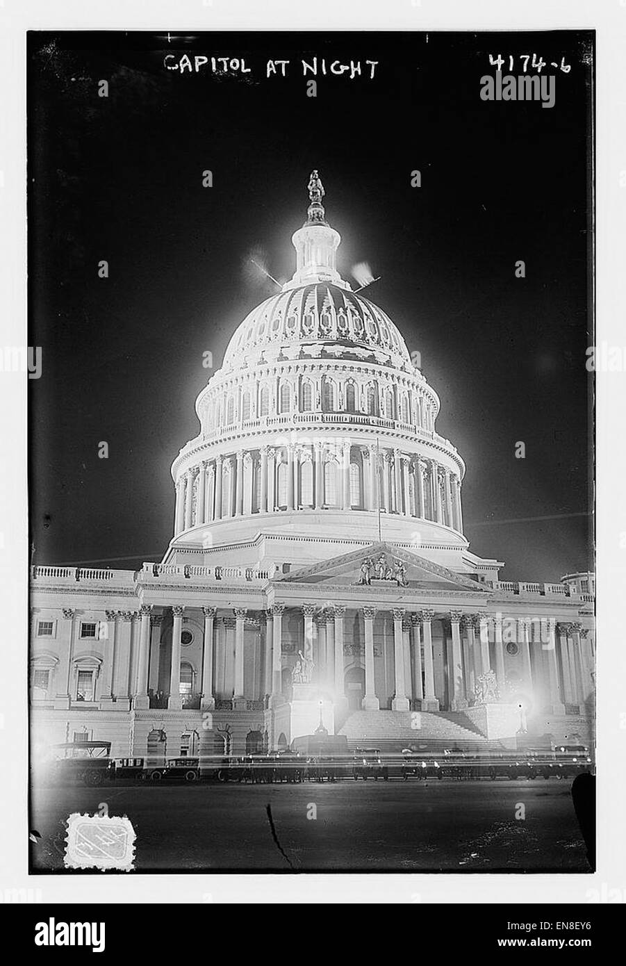 A historic photograph of the U.S. Capitol building taken at night in ...
