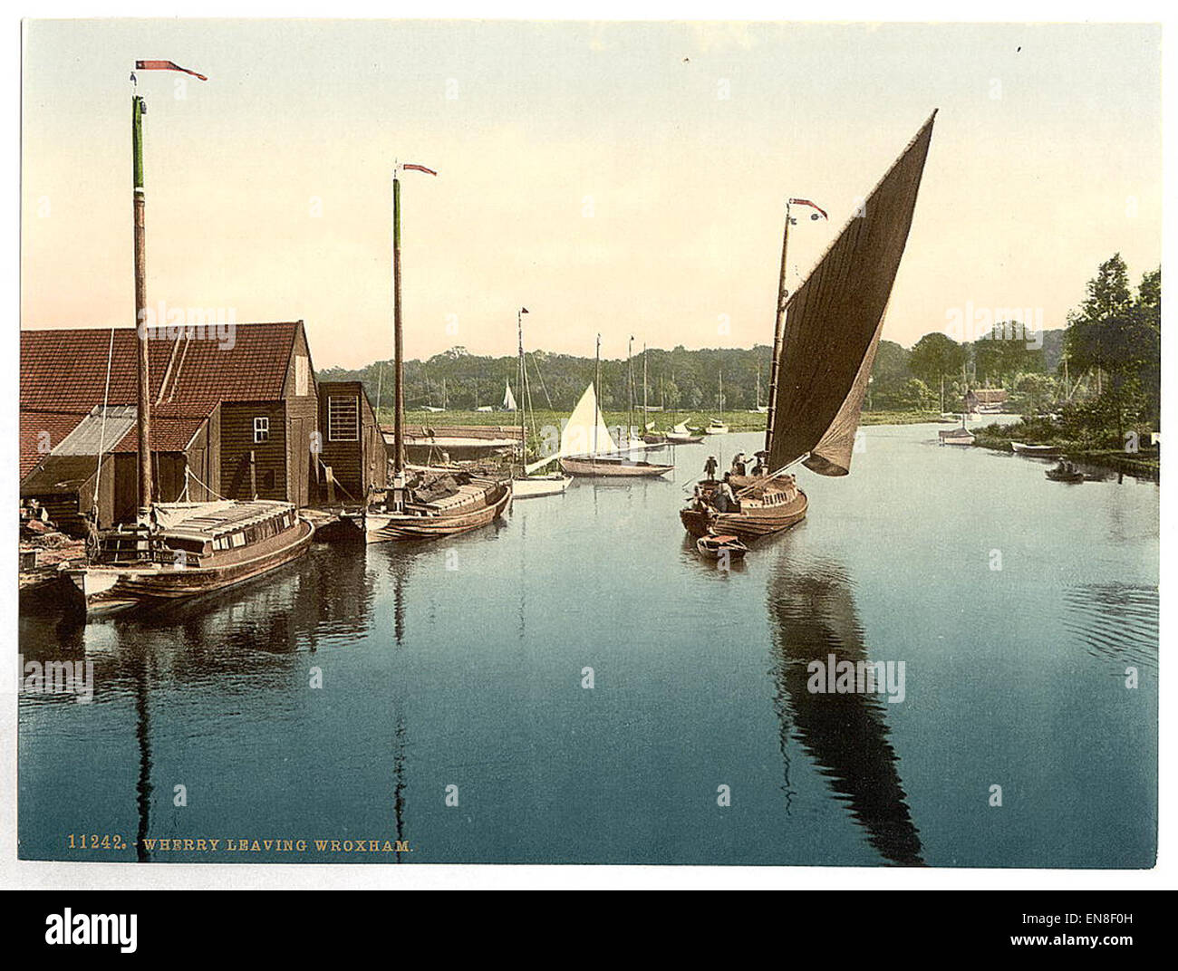 A photograph showing a wherry leaving Wroxham, England, capturing the ...