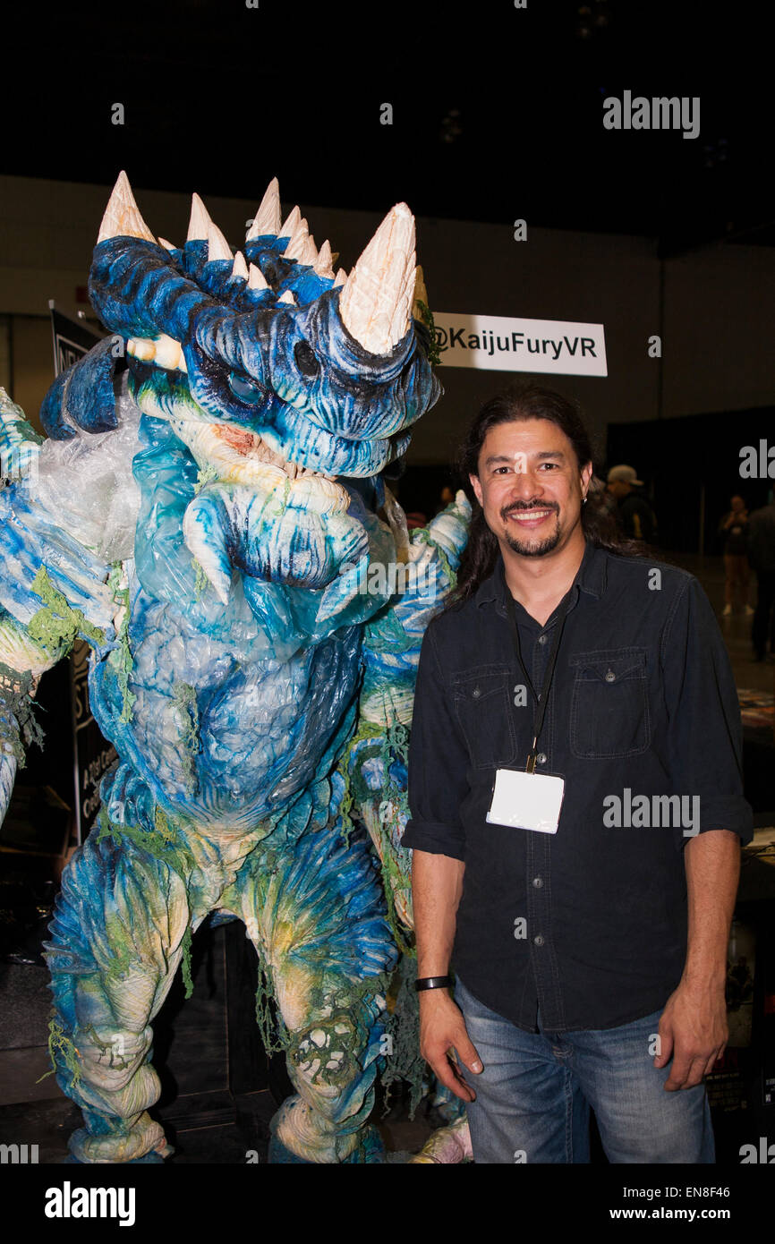 Creature builder and VR artist Fon Davis stands next to his Kaiju ...