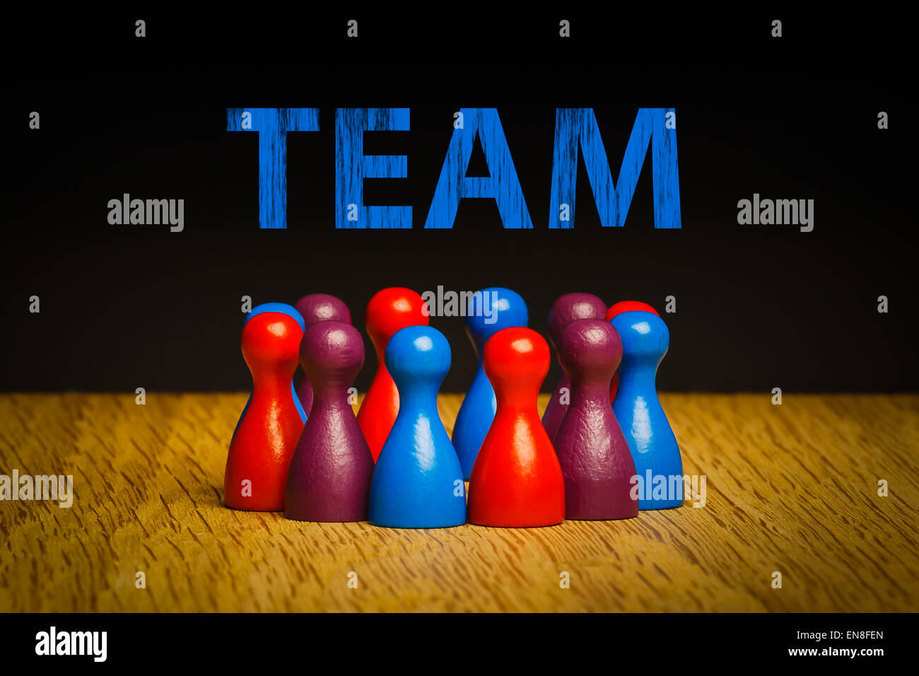 Concept for team, teamwork with text. Red blue purple pawn figures and ...