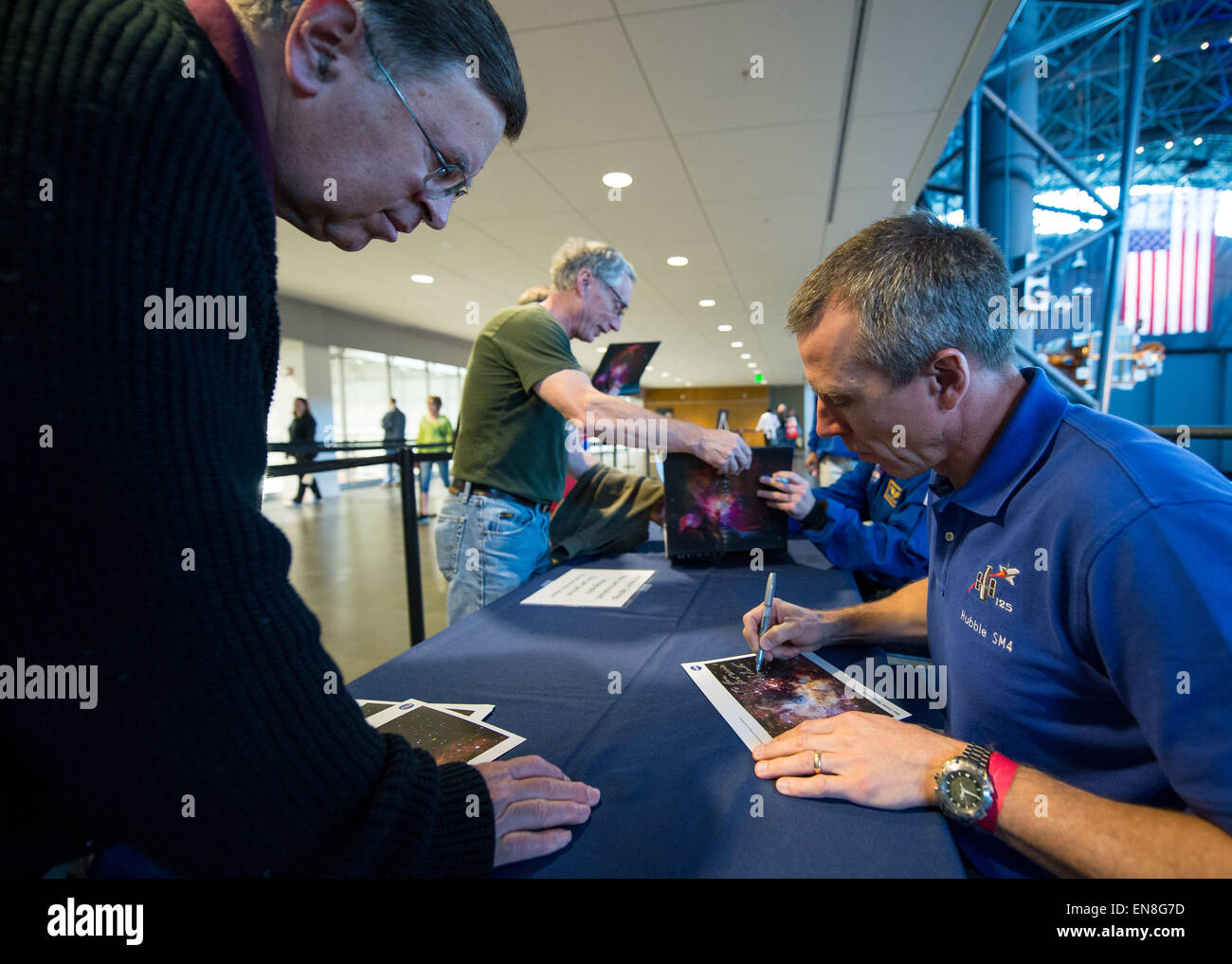 NASA astronaut Andrew Feustel signs autographs at an event celebrating ...