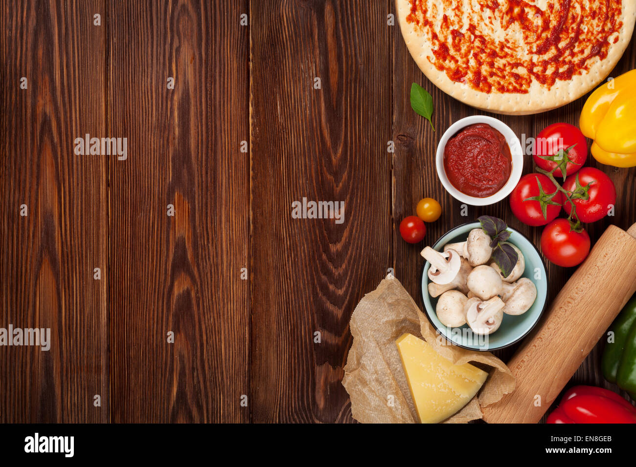 Pizza cooking ingredients. Dough, vegetables and spices. Top view with ...