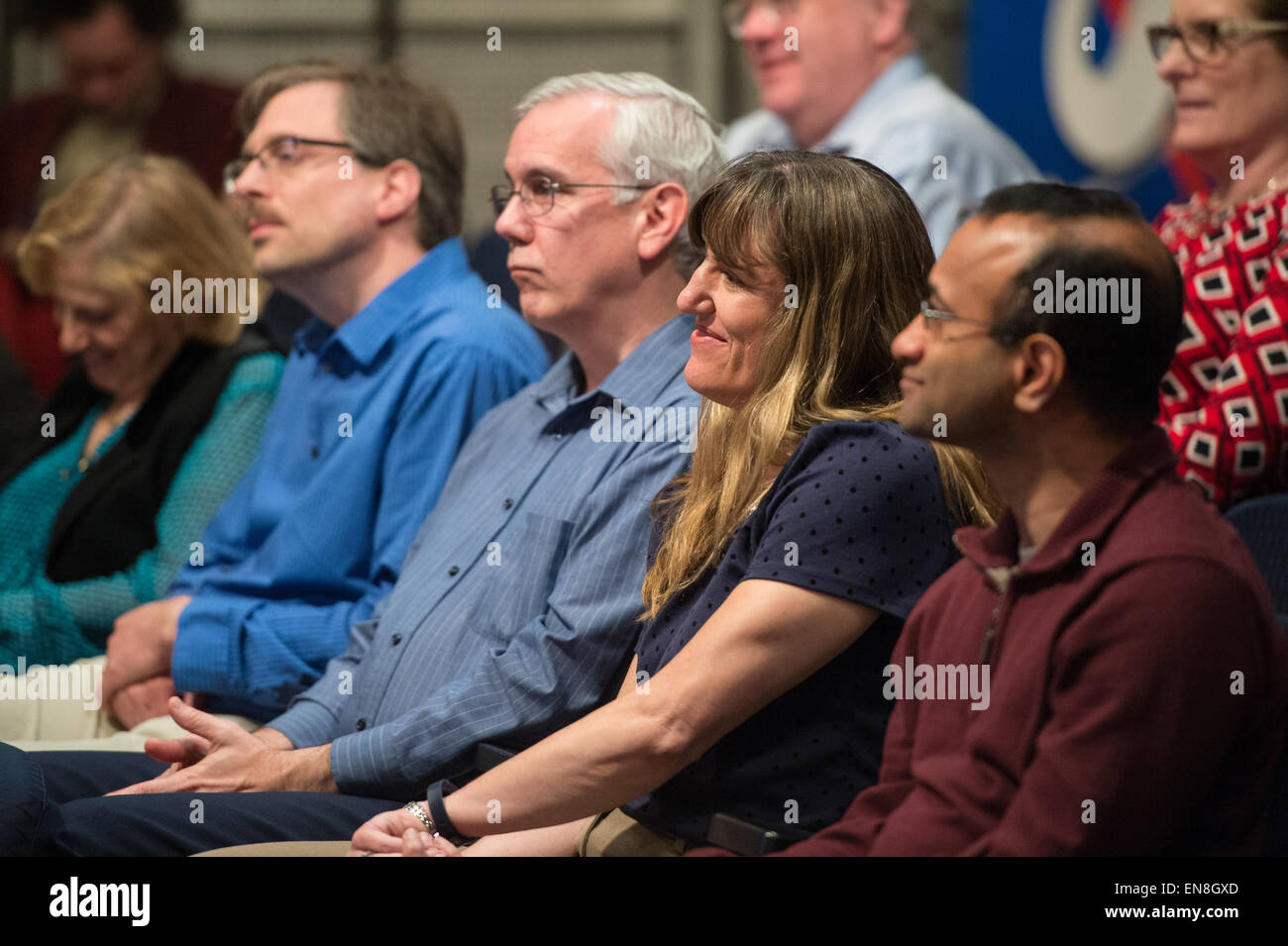 Audience members listen as panelists share scientific findings and ...