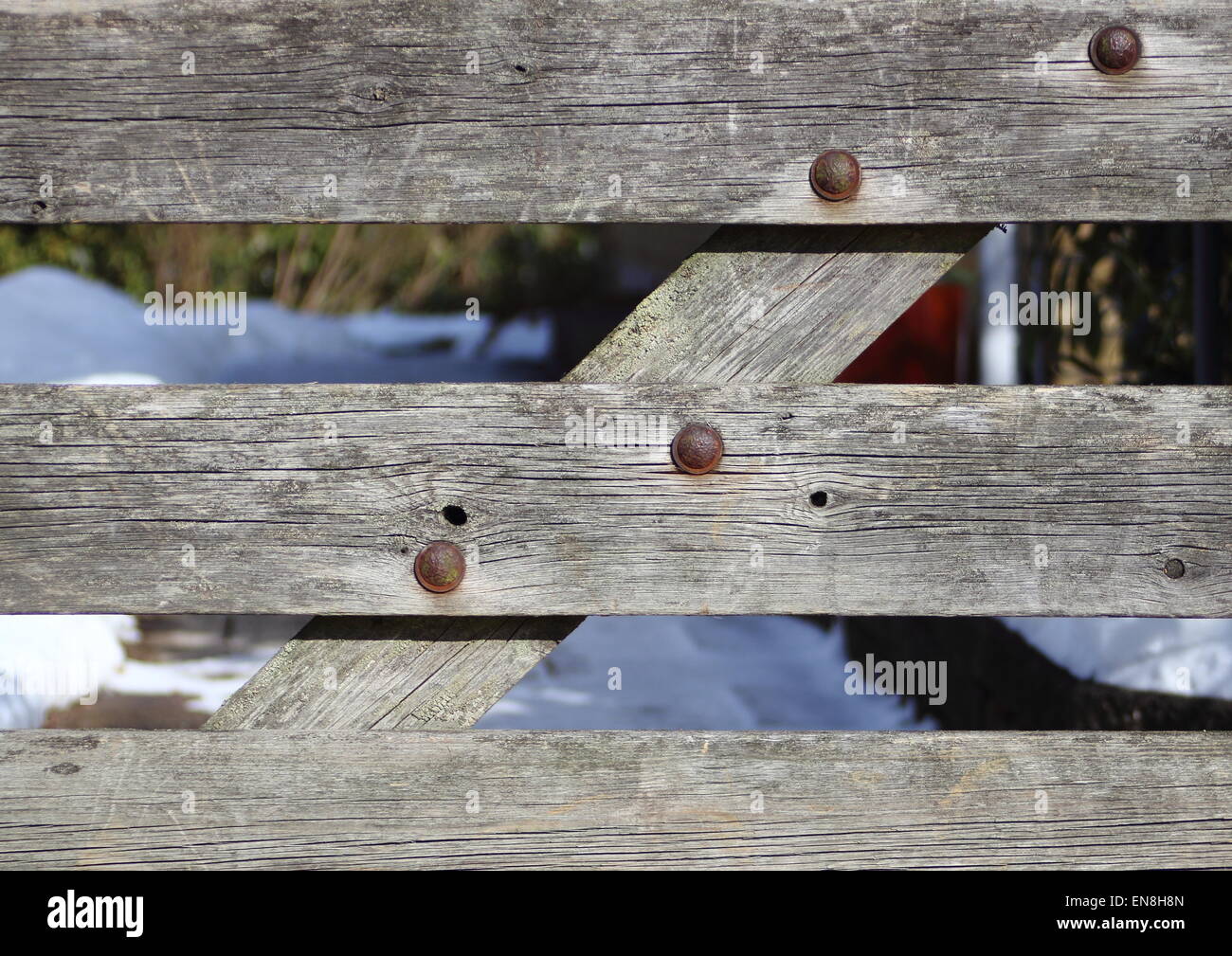 Worn wooden gate with rusty bolts Stock Photo - Alamy