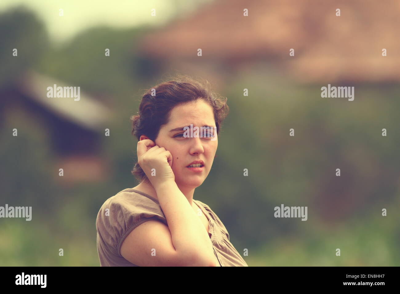 young woman outdoor portrait over out of focus background with ...