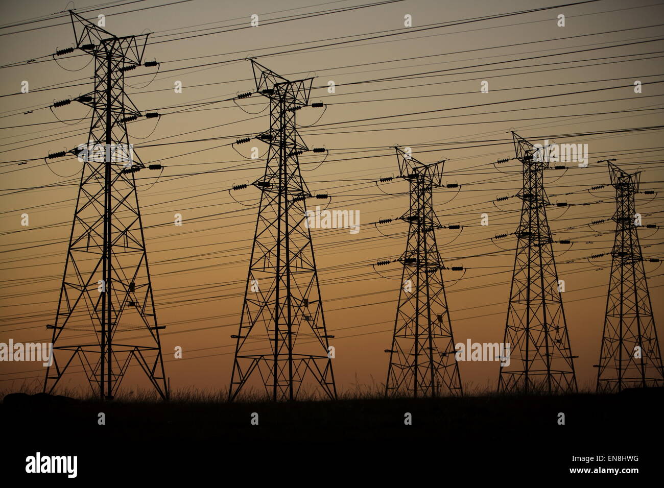 Electrical transmission power supply lines at dusk Stock Photo - Alamy