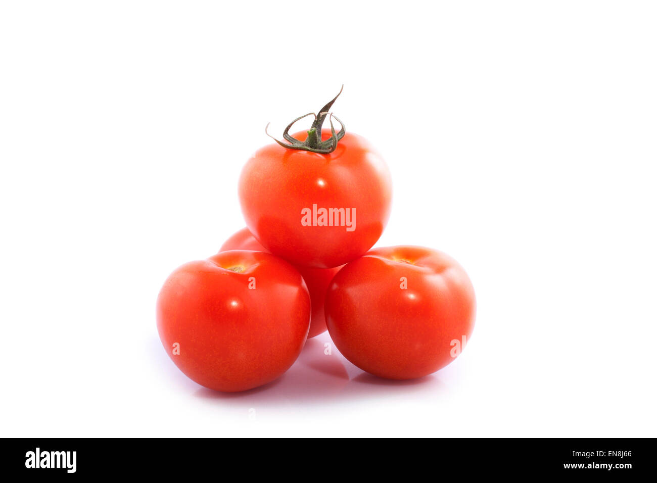 Four tomatoes isolated on a white background Stock Photo - Alamy