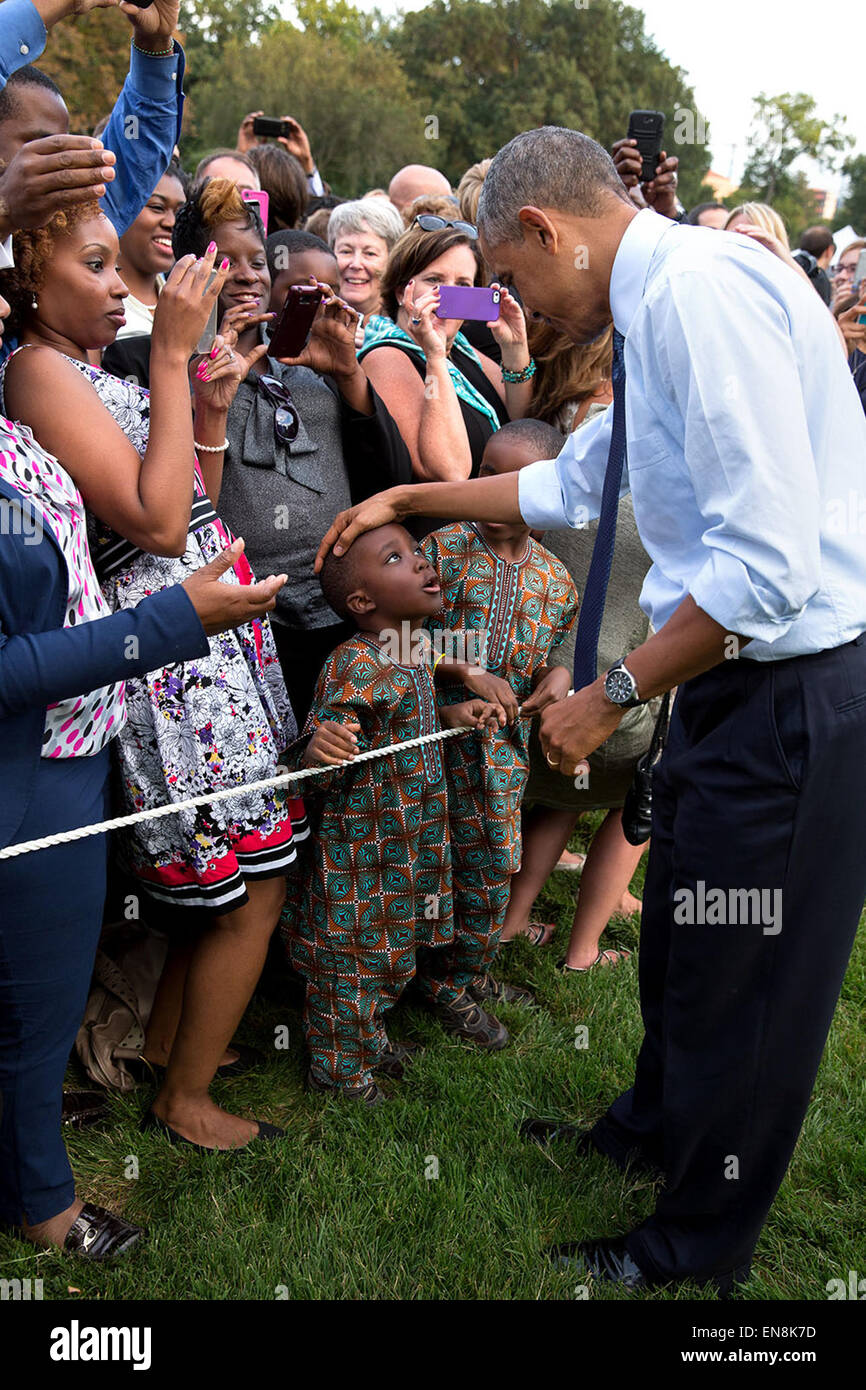 President Barack Obama greets a child during an event for political ...