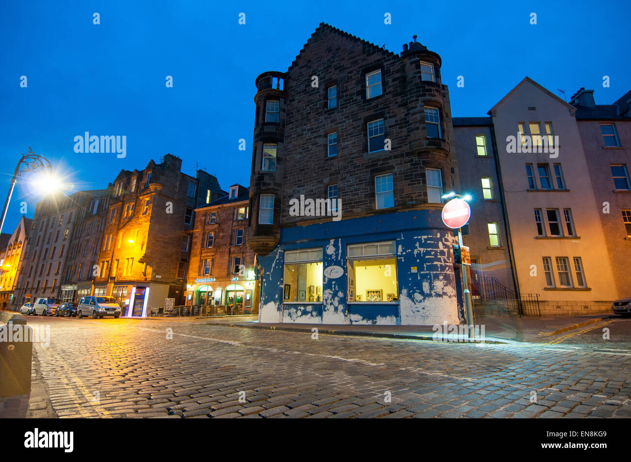Leith cobbled street with typical tenement buildings and shops taken in ...