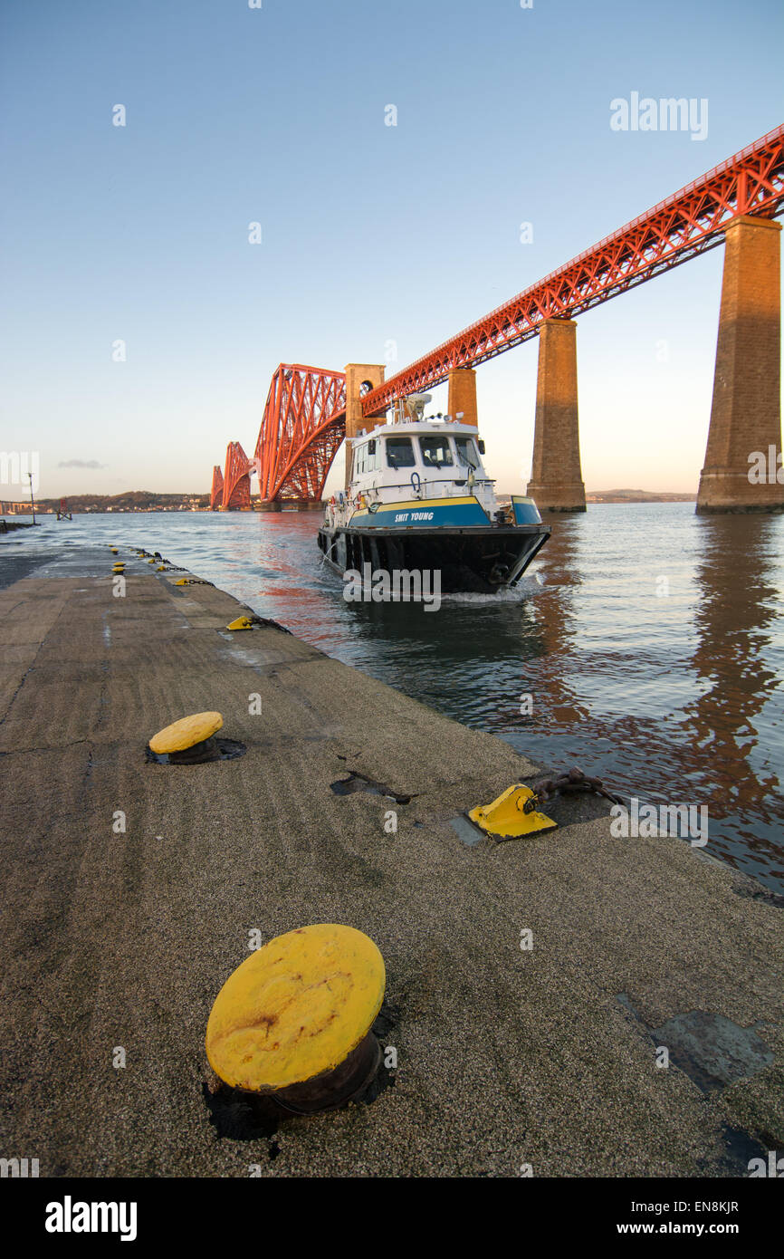 Forth Rail Bridge from the South Queensferry harbour with incoming boat ...